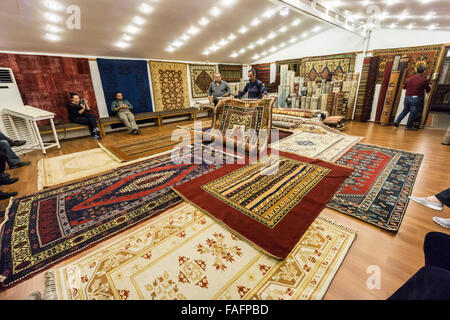 Salesman with traditional Turkish carpet rug in The Grand Bazaar ...
