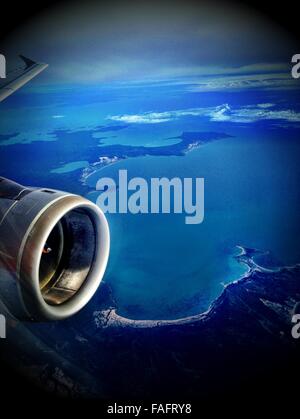 Plane wing over the ocean with islands Stock Photo - Alamy
