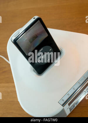 iPod charging in a bedside alarm clock dock Stock Photo - Alamy