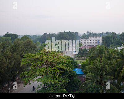 Myanmar, Burma, Rakhine State, Sittwe. An old Buddhist monk walking ...