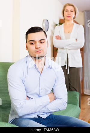 Sad young man explaining something to offended elderly woman Stock ...