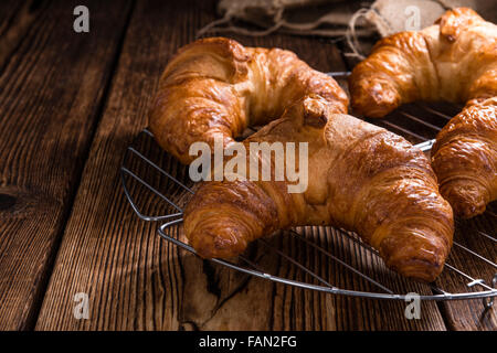 Some fresh baked Croissants on vintage wooden background Stock Photo ...