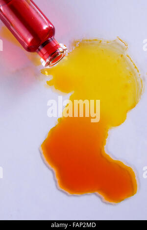 Medicine spilling from a vial Stock Photo - Alamy