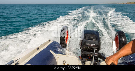 boat running fast leaving a white trail on the blue sea Stock Photo - Alamy