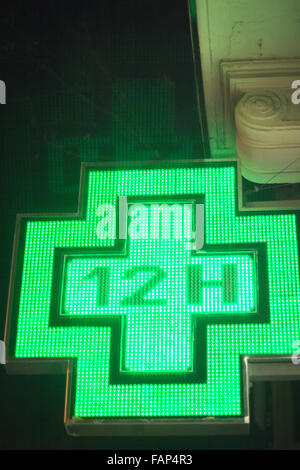 Pharmacy neon light chemists 12 hour open cross sign at night photo ...