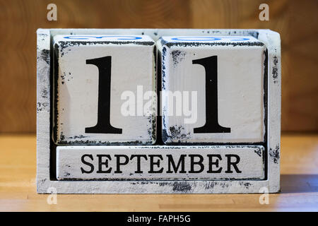 Wooden calendar with the date September 11 and gypsophila flowers on a ...