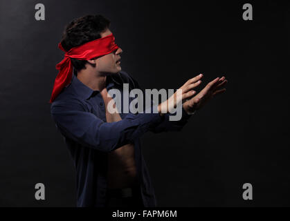 man blindfolded with red cloth Stock Photo - Alamy
