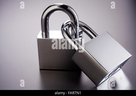 Two padlocks interlocked together on the background Stock Photo - Alamy