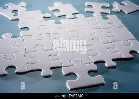 Messed up jigsaw puzzle isolated on the blue background Stock Photo - Alamy