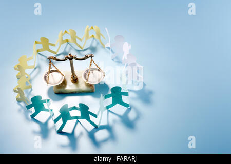 Paper chain surrounding a balance scale Stock Photo - Alamy