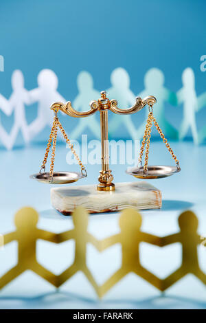 Paper chain surrounding a balance scale Stock Photo - Alamy