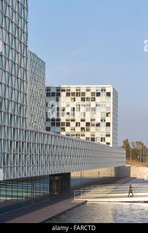Perspective of office towers with moat-style pond and bridge ...