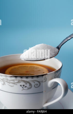 stock image of adding sugar to tea Stock Photo - Alamy