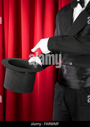 magician offer / showing his empty hat Stock Photo - Alamy