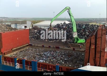 Crane loading scrap metal onto cargo ship, Newhaven, Sussex, UK Stock ...