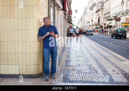Man looking at cell phone, Lisbon, Portugal Stock Photo - Alamy