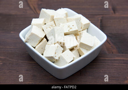 Cubes of tofu square bowl on wooden table seen from above Stock Photo ...