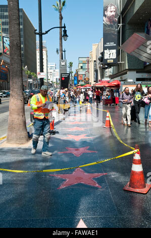 An engineer installing new star paving slabs in the pavement in ...