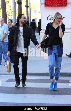 Musician Steve Aoki hold hands with his fiancee Tiernan Cowling as they ...