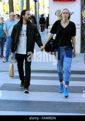 Musician Steve Aoki hold hands with his fiancee Tiernan Cowling as they ...