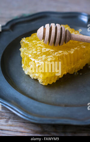 Honeycomb on slate tray with honey and nuts on kitchen table Stock ...
