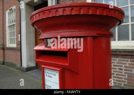 A red old fashioned letter box with a brick wall background Stock Photo ...