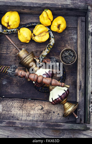 Copper shisha in wooden box with fruit quince Stock Photo - Alamy