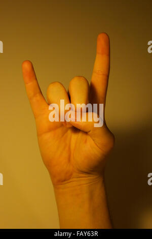 Rock gesture hand sign with index finger and pinky raised, symbol of ...