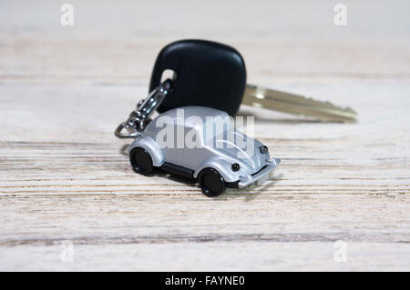 Car toy with car key on wood table Stock Photo - Alamy