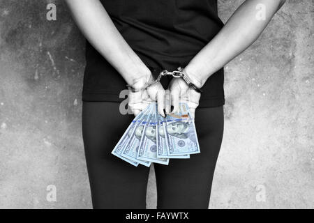 Arrested female with hands cuffed standing against a wall Stock Photo ...