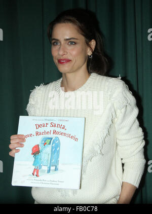 Author Andrea Troyer and actress Amanda Peet sign copies of their book ...