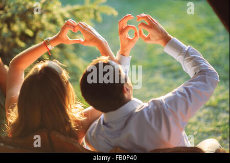 Valentines couple make heart shape with hands Stock Photo - Alamy
