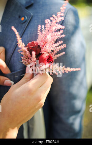 Pinning a Boutonniere Stock Photo - Alamy