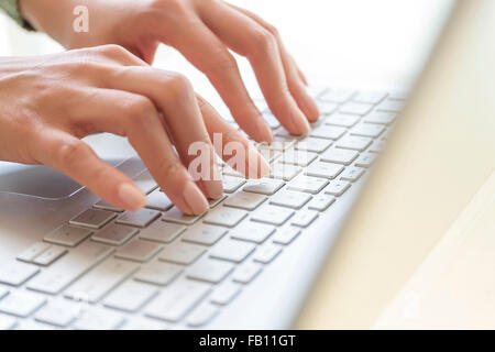 Hands typing on laptop keyboard close up on pink Stock Photo - Alamy