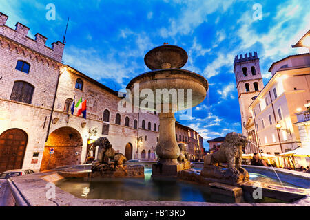 Fountain in the Piazza del Comune with the Roman Temple of Minerva and ...