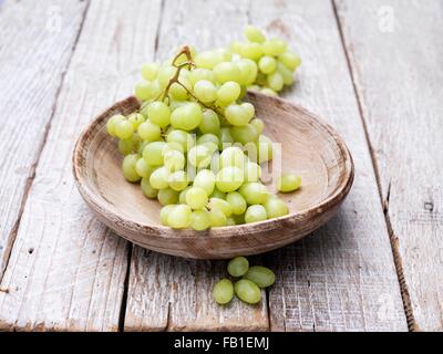 Fresh grapes in wooden bowl on wooden table Stock Photo - Alamy