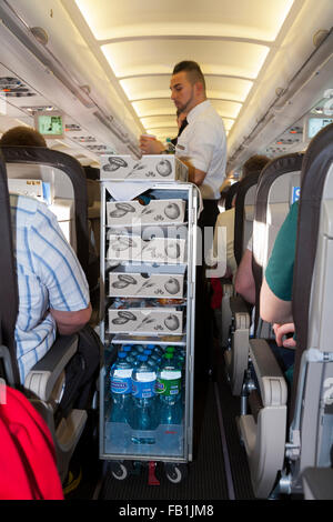 Food carts with meals for passengers on the plane. Storage space on the ...