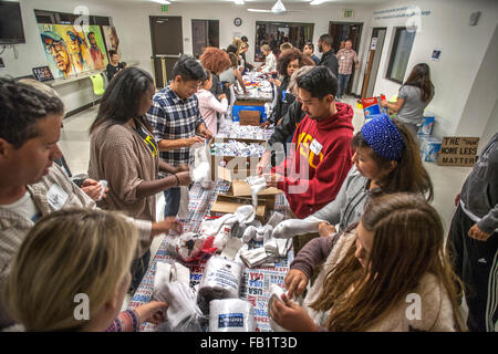 Volunteers giving clothes to homeless people outdoors Stock Photo - Alamy