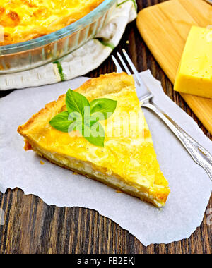 Homemade leek quiche with a baked cheese crust in a glass dish, cooling ...