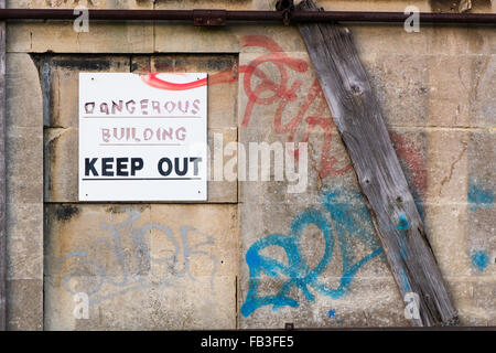 Sign warning of a dangerous building and to keep out. The building has ...