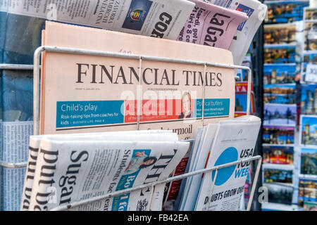 Various international newspapers and magazines in a newspaper stand ...