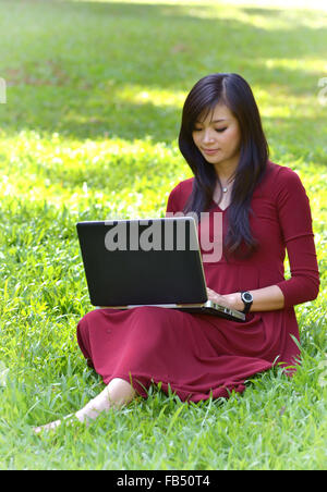 Laptop computer on green grass with coffee cup and tablet in outdoor ...