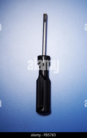 screw driver on blue background Stock Photo - Alamy