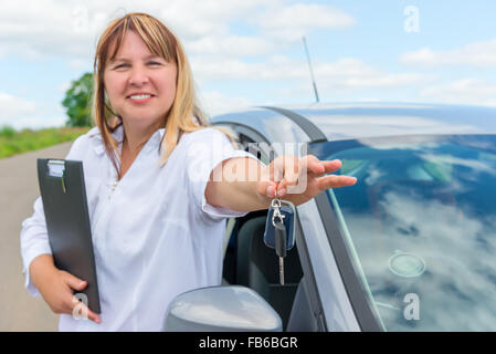 Mature woman with key near car outdoors Stock Photo - Alamy