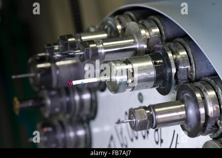Rotating head with drilling machine bits and tools in a high precision mechanics plant at CNC ...