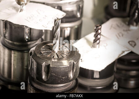 Rotating head with drilling machine bits and tools in a high precision mechanics plant at CNC ...