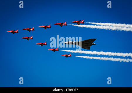 Avro Vulcan bomber and Red Arrows RAF BAe Hawk aircraft in formation at RIAT 2015, Fairford, UK ...