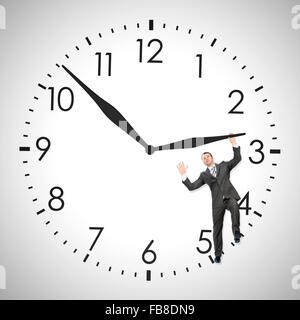 Businessman pushing clock hand Stock Photo - Alamy