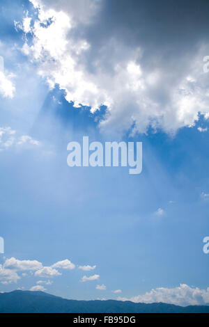 Sun beaming from behind clouds Stock Photo - Alamy