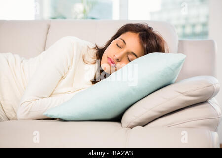 Beautiful brunette taking a nap lying on the couch Stock Photo - Alamy